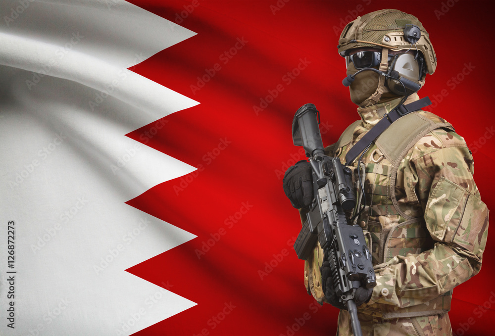 Soldier in helmet holding machine gun with flag on background series ...