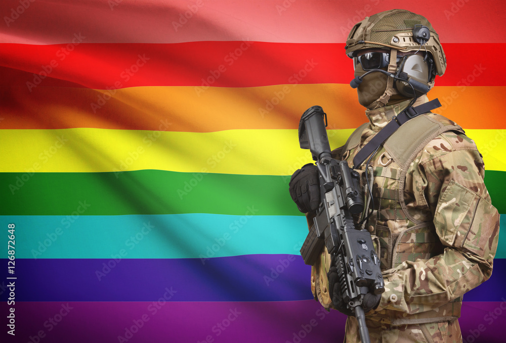 Soldier in helmet holding machine gun with flag on background series ...