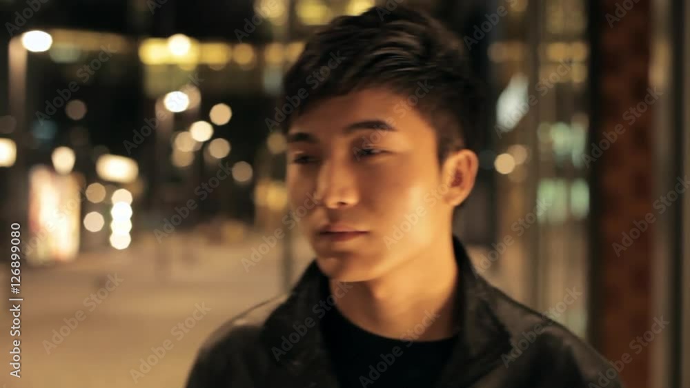 TS Young man walking on the street at night Stock ビデオ | Adobe Stock