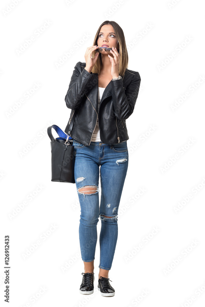 Trendy modern street style fashion girl taking off sunglasses looking ...