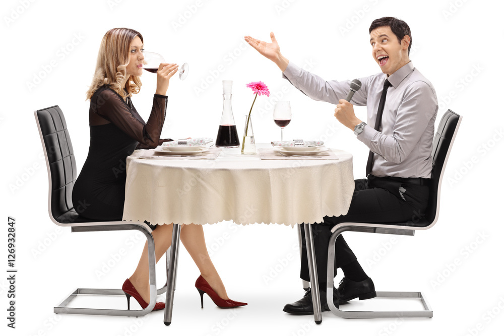 Man singing to a woman at a restaurant table Stock Photo | Adobe Stock