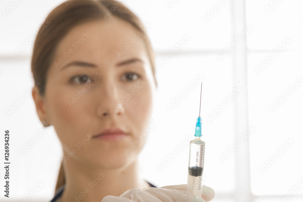 Medical doctor with syringe. Young female nurse with syringe Stock ...