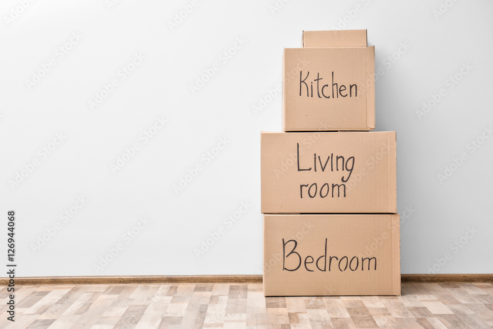 Empty room with moving boxes on wall background Stock Photo | Adobe Stock