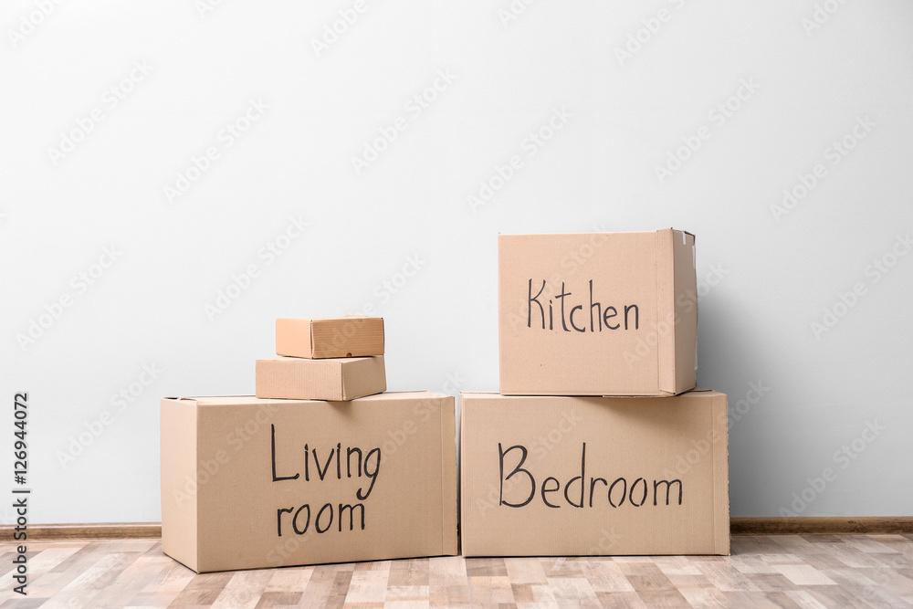 Empty room with moving boxes on wall background Stock Photo | Adobe Stock