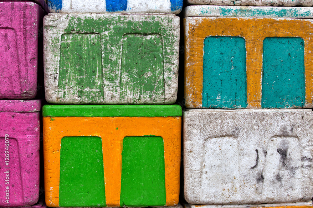 pile of bright colored styrofoam boxes at a fish market somewhere in ...