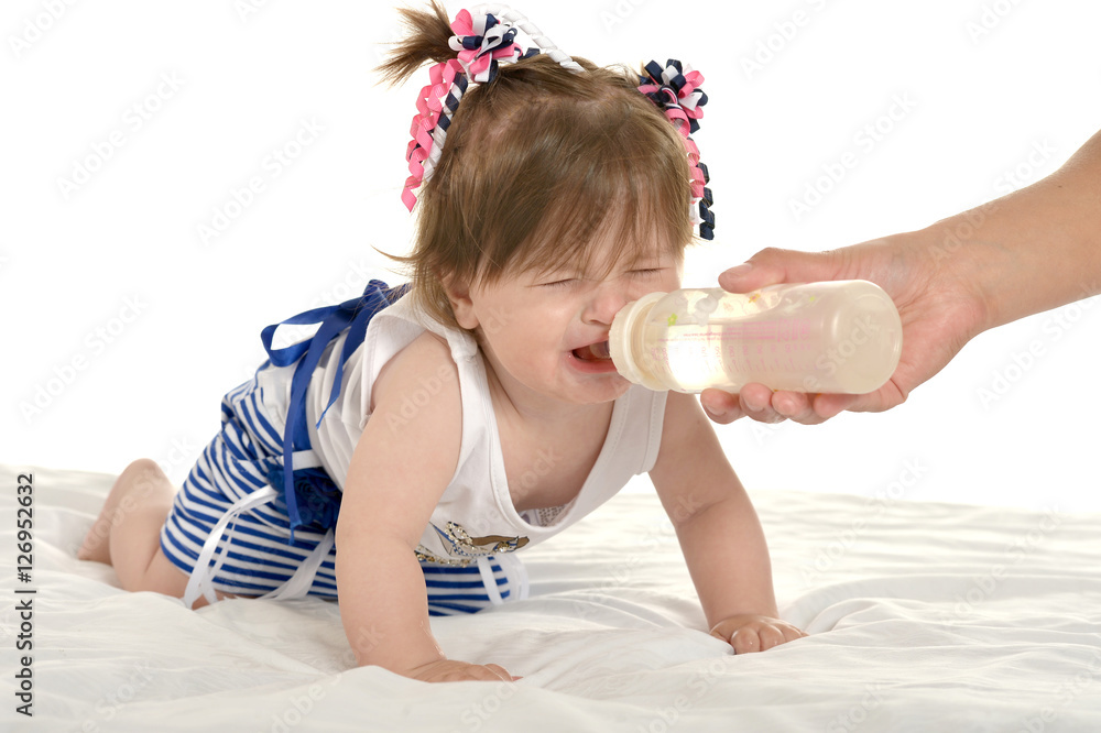 Girl crying while drinking milk Stock Photo | Adobe Stock