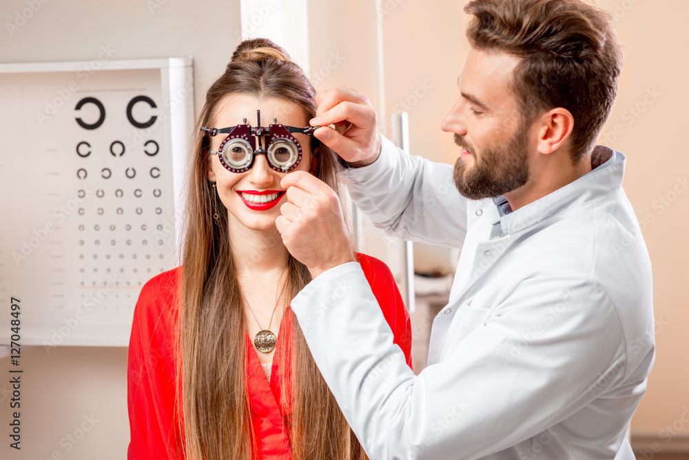 Ophthalmologist Wearing Try on Tool For Vision Check To The Young ophthalmologist-wearing-try-on-tool-for-vision-check-to-the-young