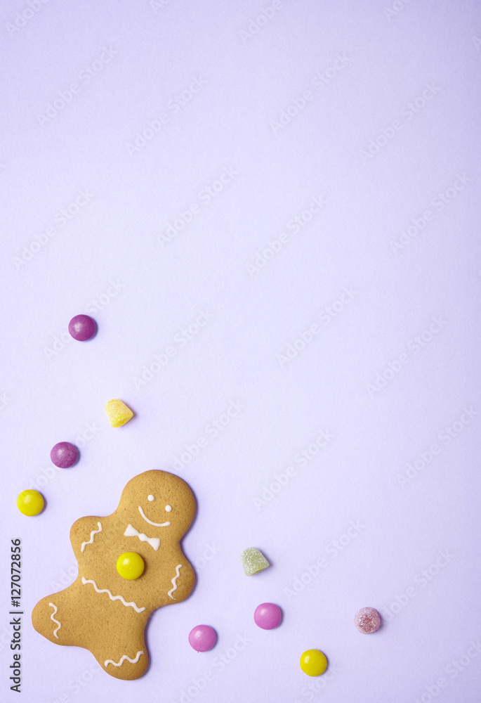 Hand decorated gingerbread men on a pastel purple background with ...