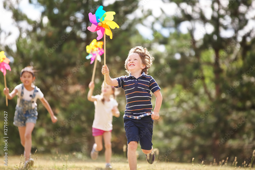 Children with pinwheels Stock Photo | Adobe Stock
