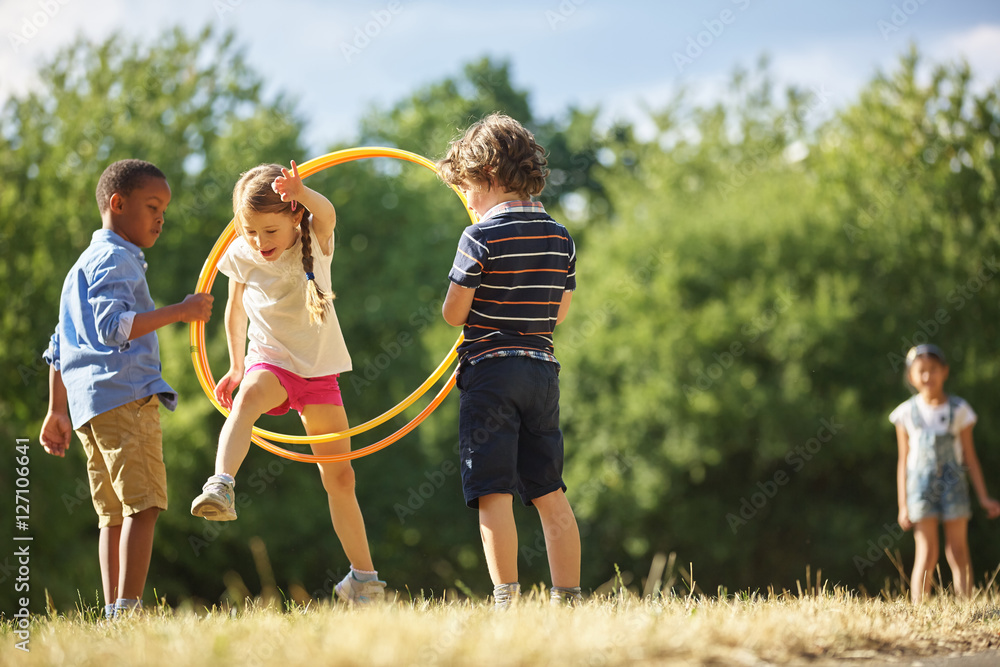 Girl jumps through hula hoop Stock Photo | Adobe Stock