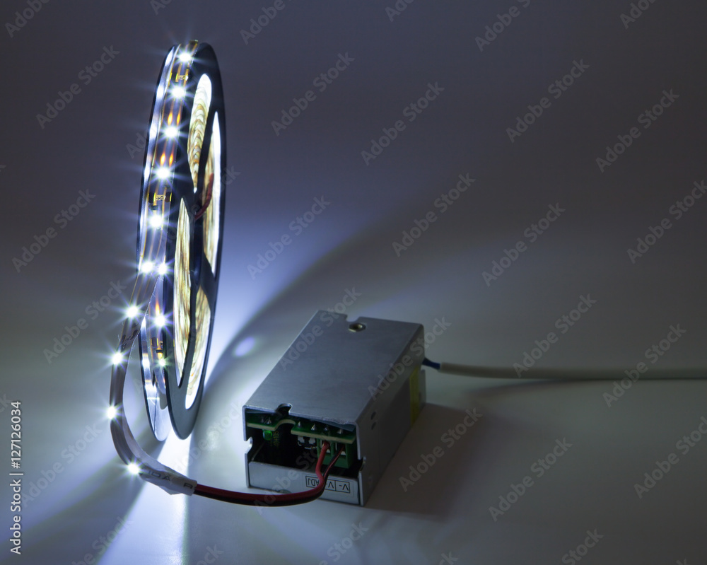 Spool of luminous LED strip light connected to Power Supply. Stock-Foto ...
