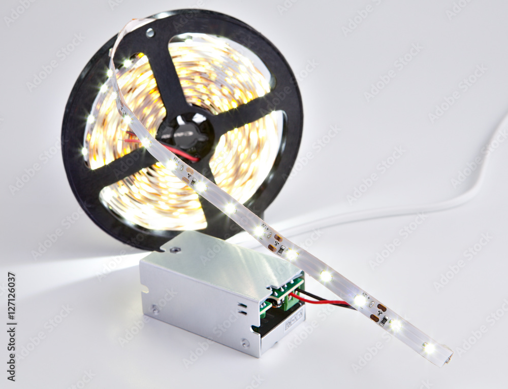 Spool of luminous LED strip light connected to Power Supply. Stock ...