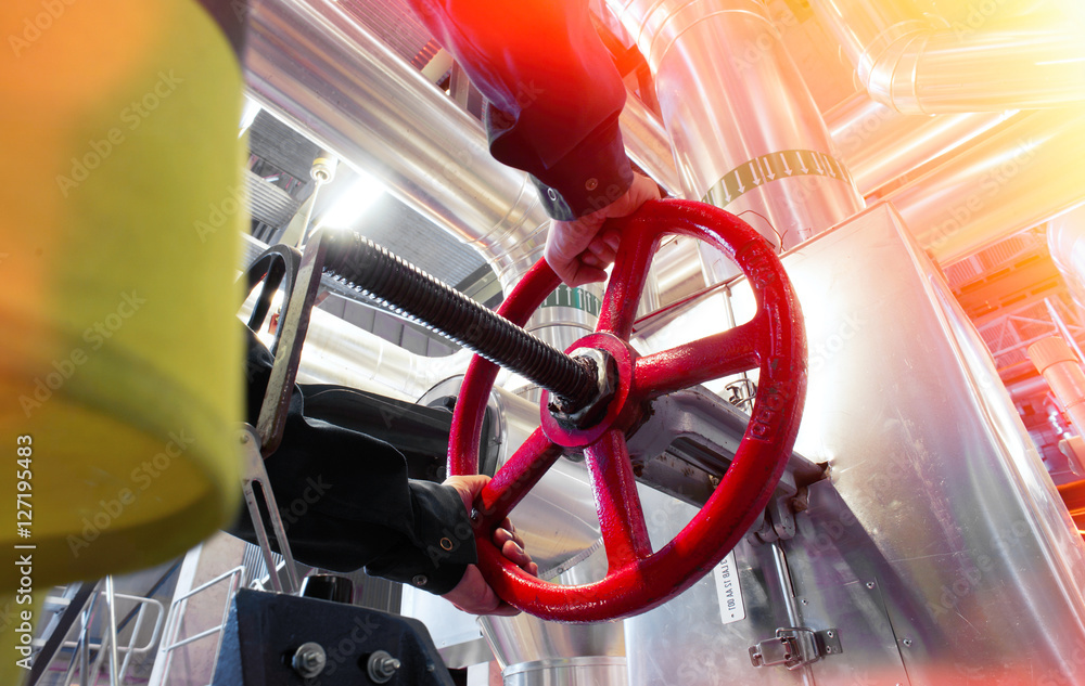factory worker turning valve Stock Photo | Adobe Stock