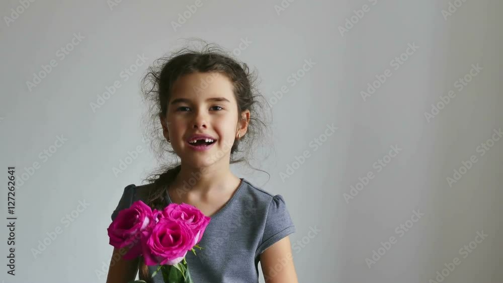 Girl child holding a bouquet of flower rose indoor Stock Video | Adobe ...
