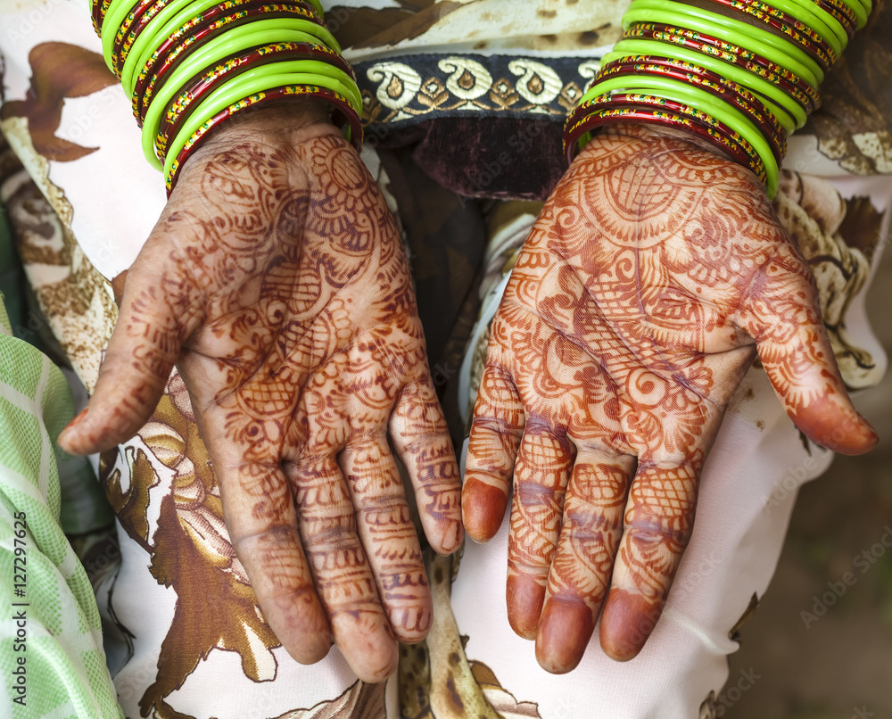 drawing henna patterns on arm indian woman Stock Photo | Adobe Stock