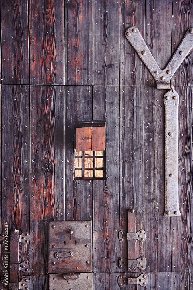 Ancient wooden gate with peep hole, grate, iron enhancement and massive ...