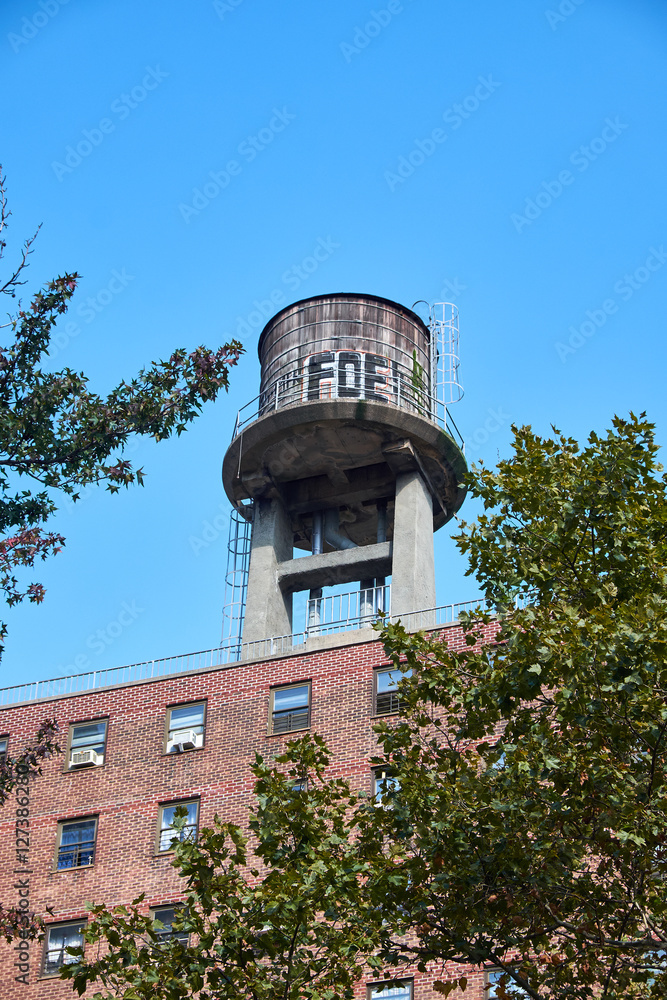 Roof top water tank, with graffiti, made of wood on the top of a New ...