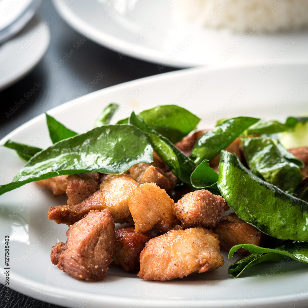 Deep fried pork with leech lime leaf and chili sauce Stock Photo ...
