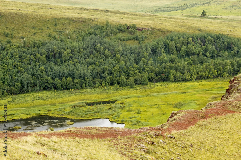 Russia. Khakassia. Western Sayan. Chests mountain range in fog. Lake ...