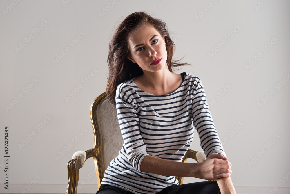 Beautiful model woman posing in studio with a vintage armchair Stock ...