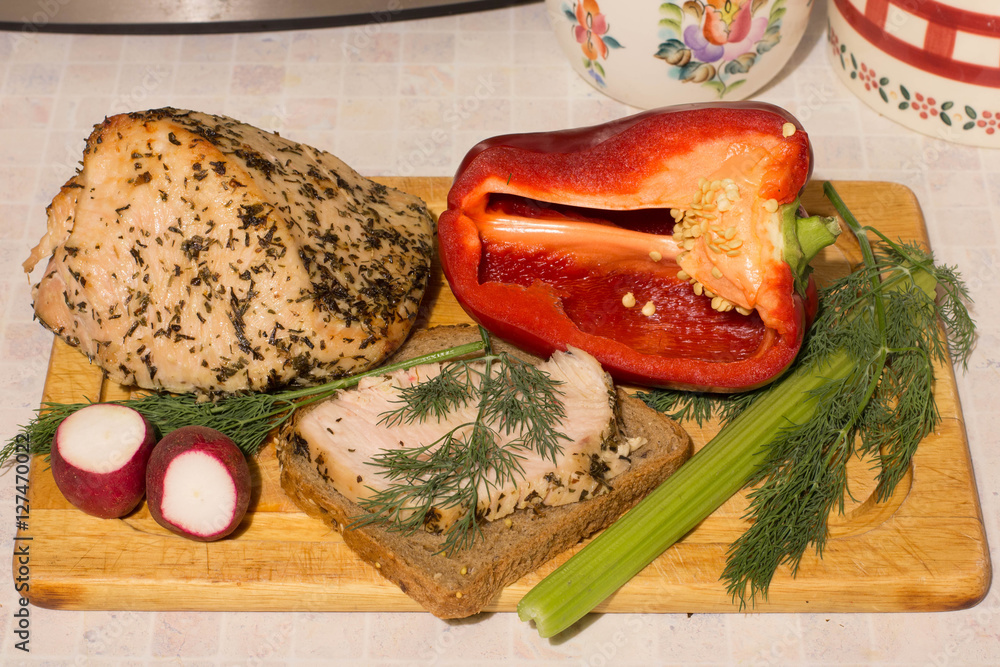 Turkey with selderey, parsley and radishes on a cutting Board on the ...