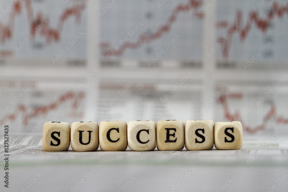 Success word built with letter cubes on newspaper background Stock ...