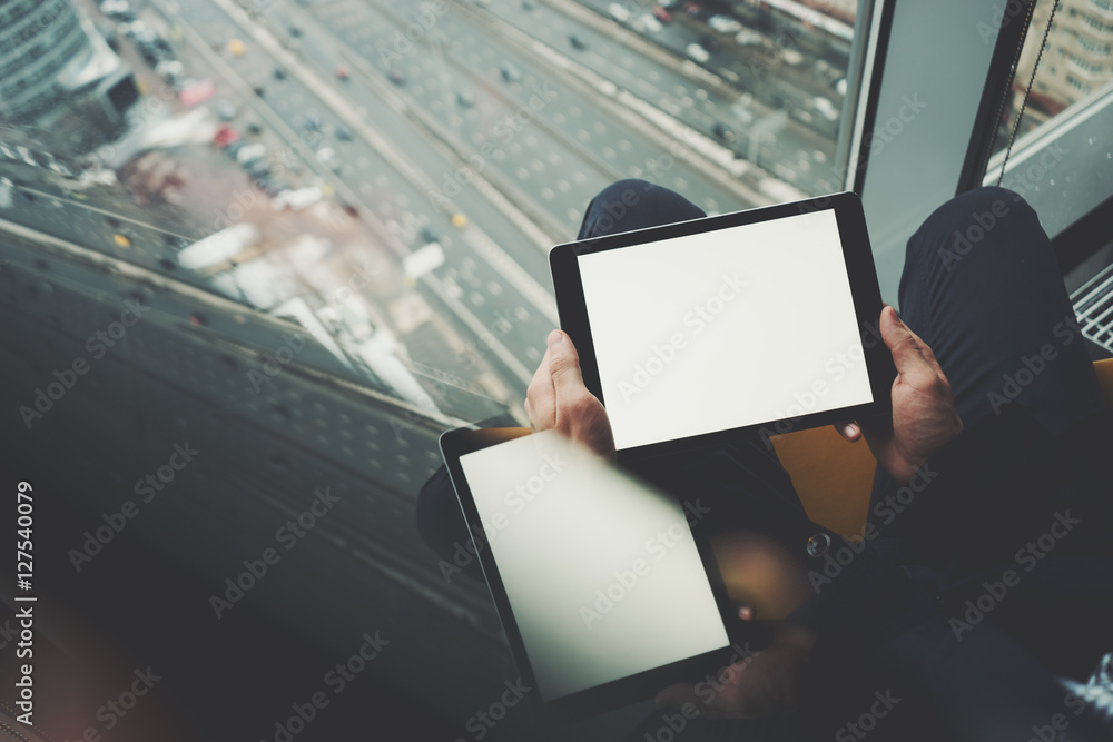 Close up view of mock up template of tablet pc in hands of man sitting ...