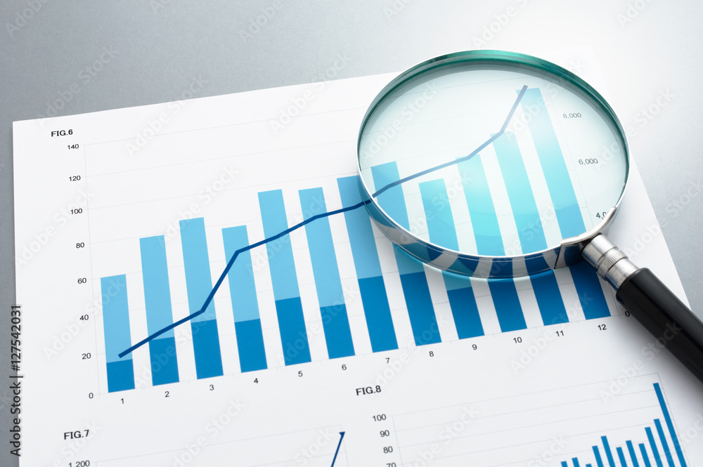 Document, charts and magnifying glass on gray reflection background ...