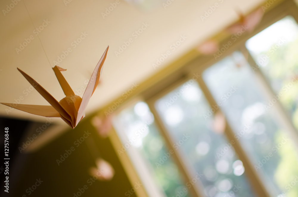 Paper cranes hanging from the ceiling. Only one of the paper cranes is ...
