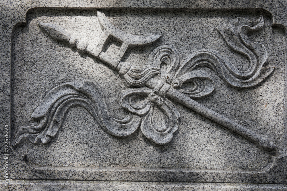 The object of the granite carving is a halbert. Halbert is a two-handed ...