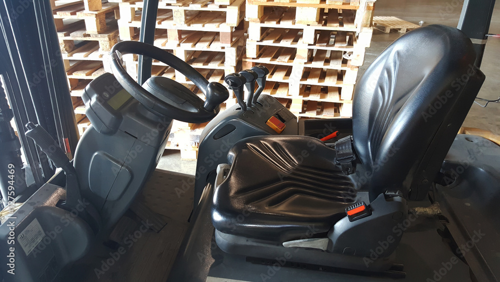 side view of controlling panel and seat of Forklift in loading ...