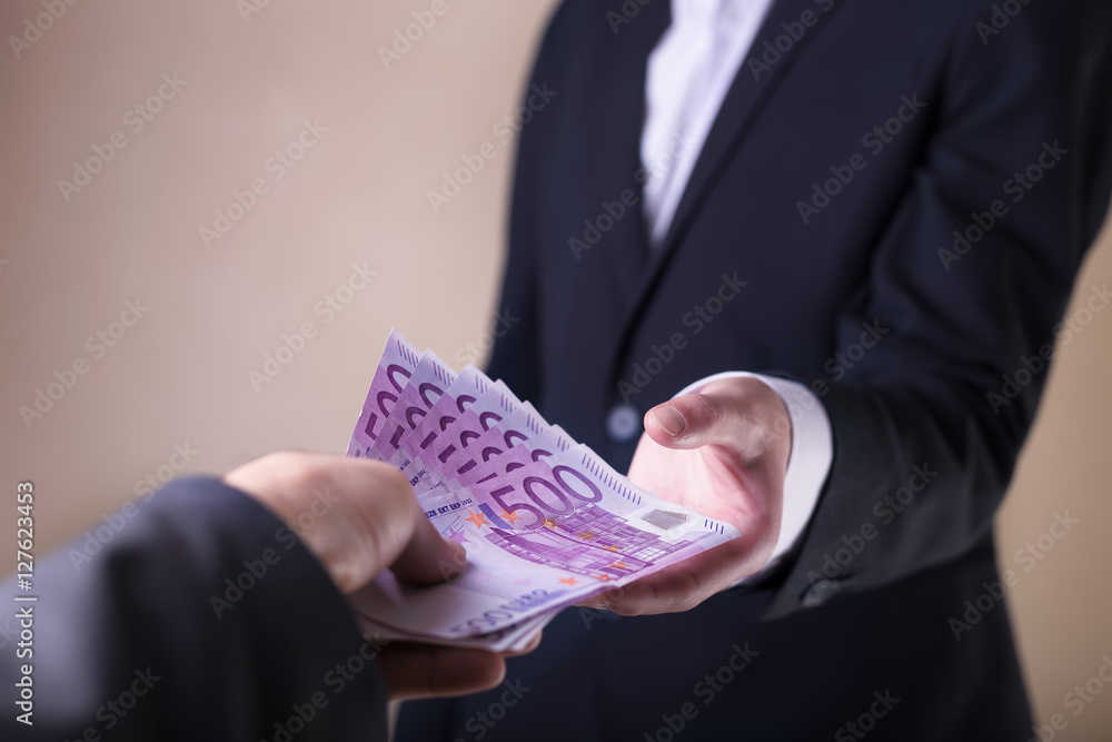 Bribe and corruption with euro banknotes. Stock Photo | Adobe Stock