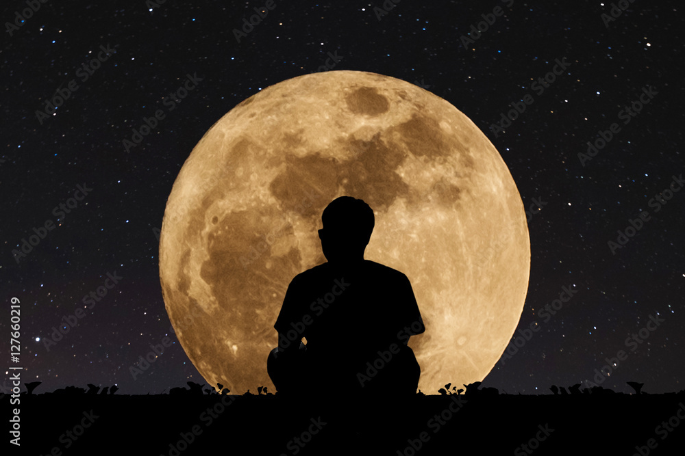 Silhouette a man sitting relaxing under full moon at night with stars ...