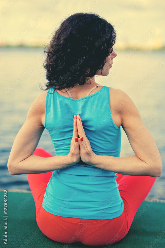 sitting in the lotus position, hands clasped behind his back, the view ...