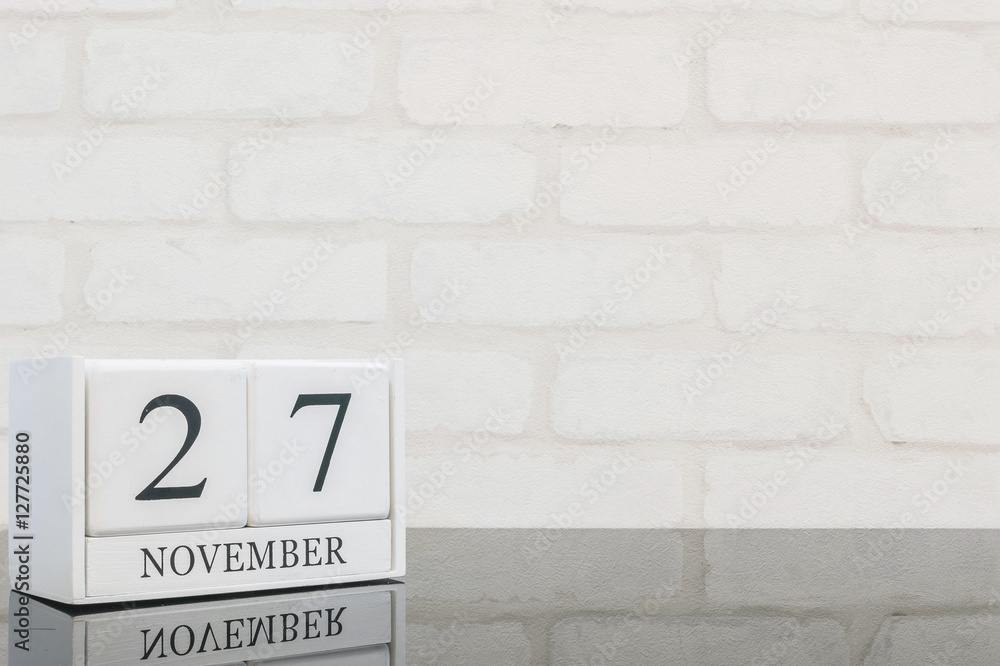 Closeup white wooden calendar with black 27 november word on black ...