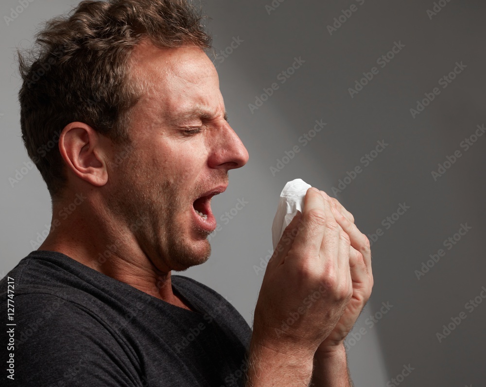 sneezing man with cold Stock Photo | Adobe Stock