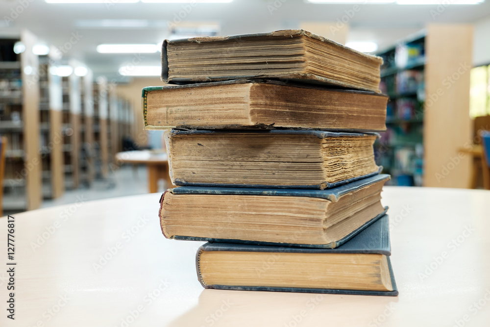 Stack of old books in library Stock Photo | Adobe Stock