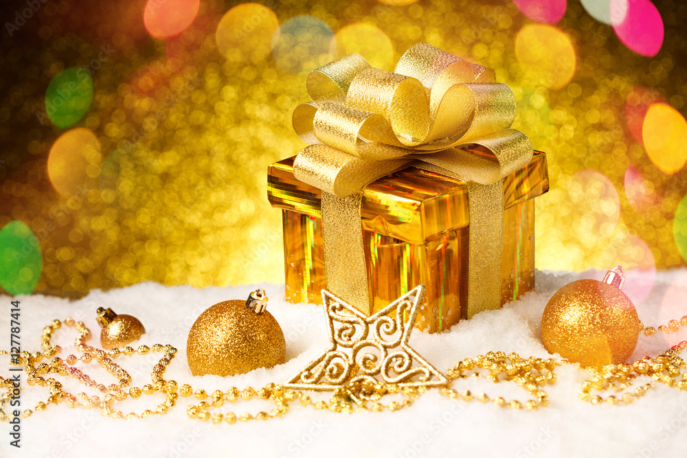 Christmas gold gift box with balls and star on snow Stock Photo | Adobe ...