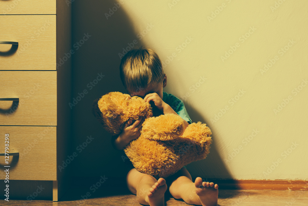 Scared boy hugging his teddy bear and crying Stock Photo | Adobe Stock