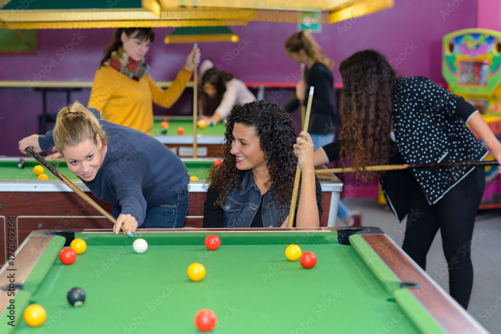 team standing at pool table Stock Photo | Adobe Stock