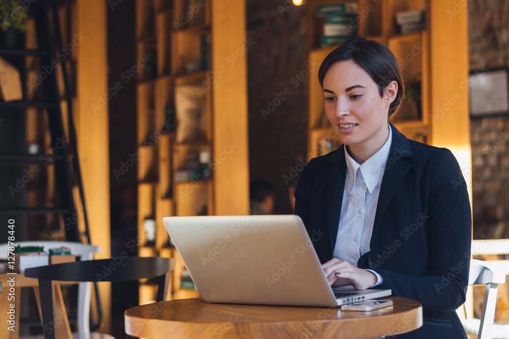 Confident business woman looking at laptop computer screen. Fema Stock ...