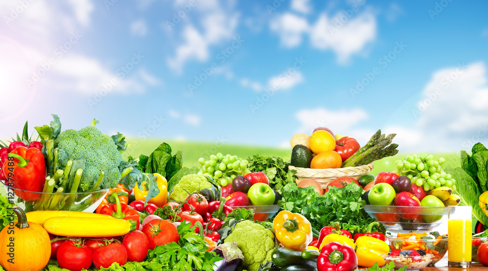 Vegetables and fruits over blue sky background. Stock Photo | Adobe Stock