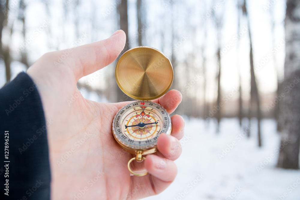Concept - orienteering in the woods, a route. Winter, man holds compass ...