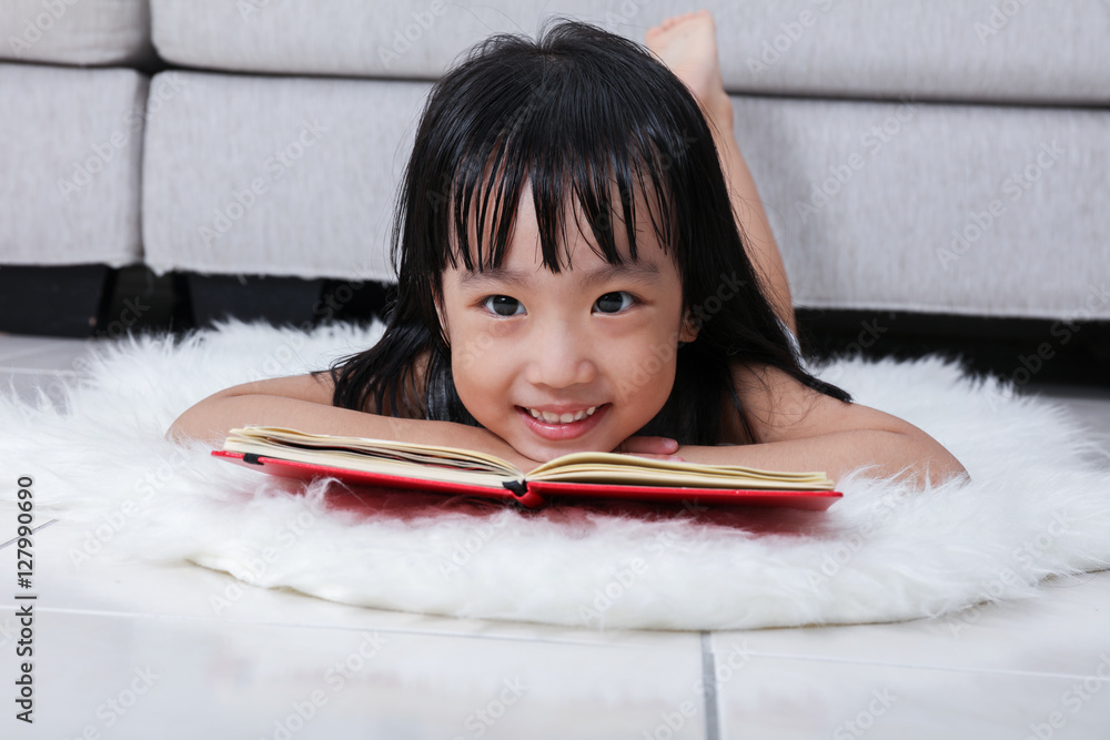 Happy Asian Chinese little girl reading book on the floor Stock Photo ...