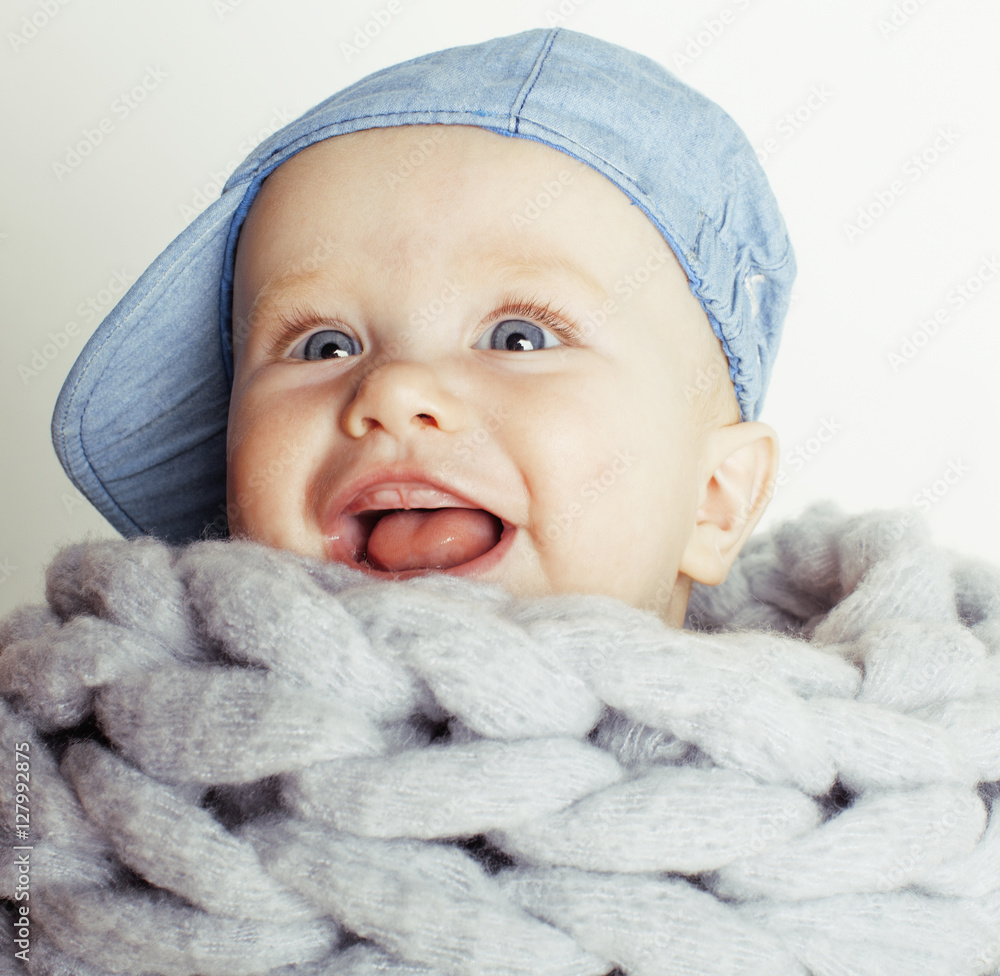 little cute red head baby in scarf all over him close up isolated ...