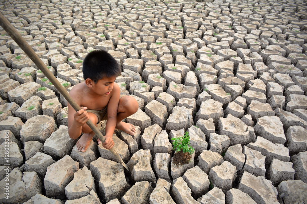 Sad a boy sitting on dry ground .concept drought and hope Stock Photo ...