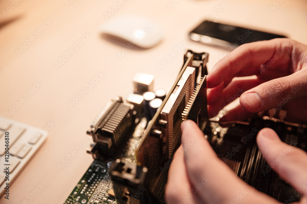 Man hands installing microprocessor into motherboard on the table Stock ...
