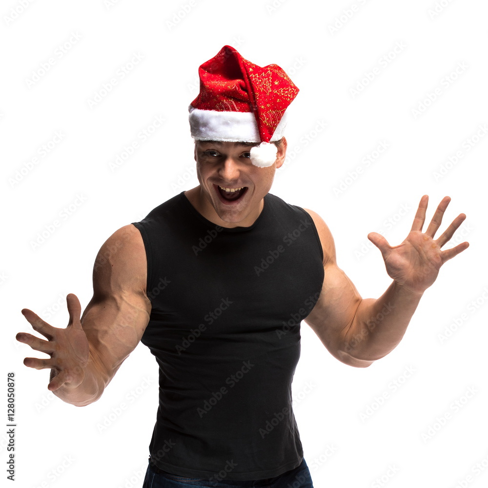 athlete bodybuilder posing with a beard and a cap of Santa Claus on a ...