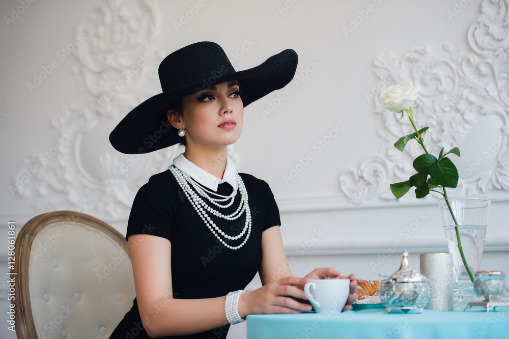 Woman in hat, much like the famous actress, croissant eating and ...