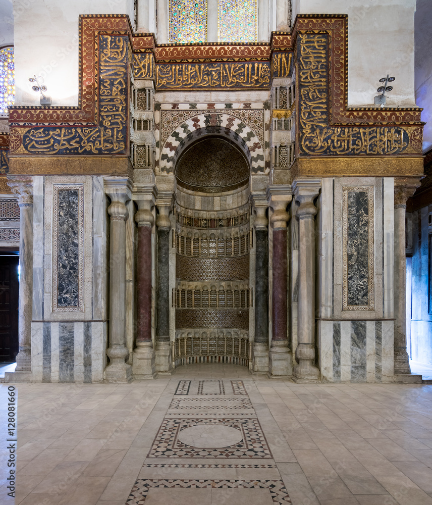 Interior view of ornate sculpted mihrab (niche) in front of the ...